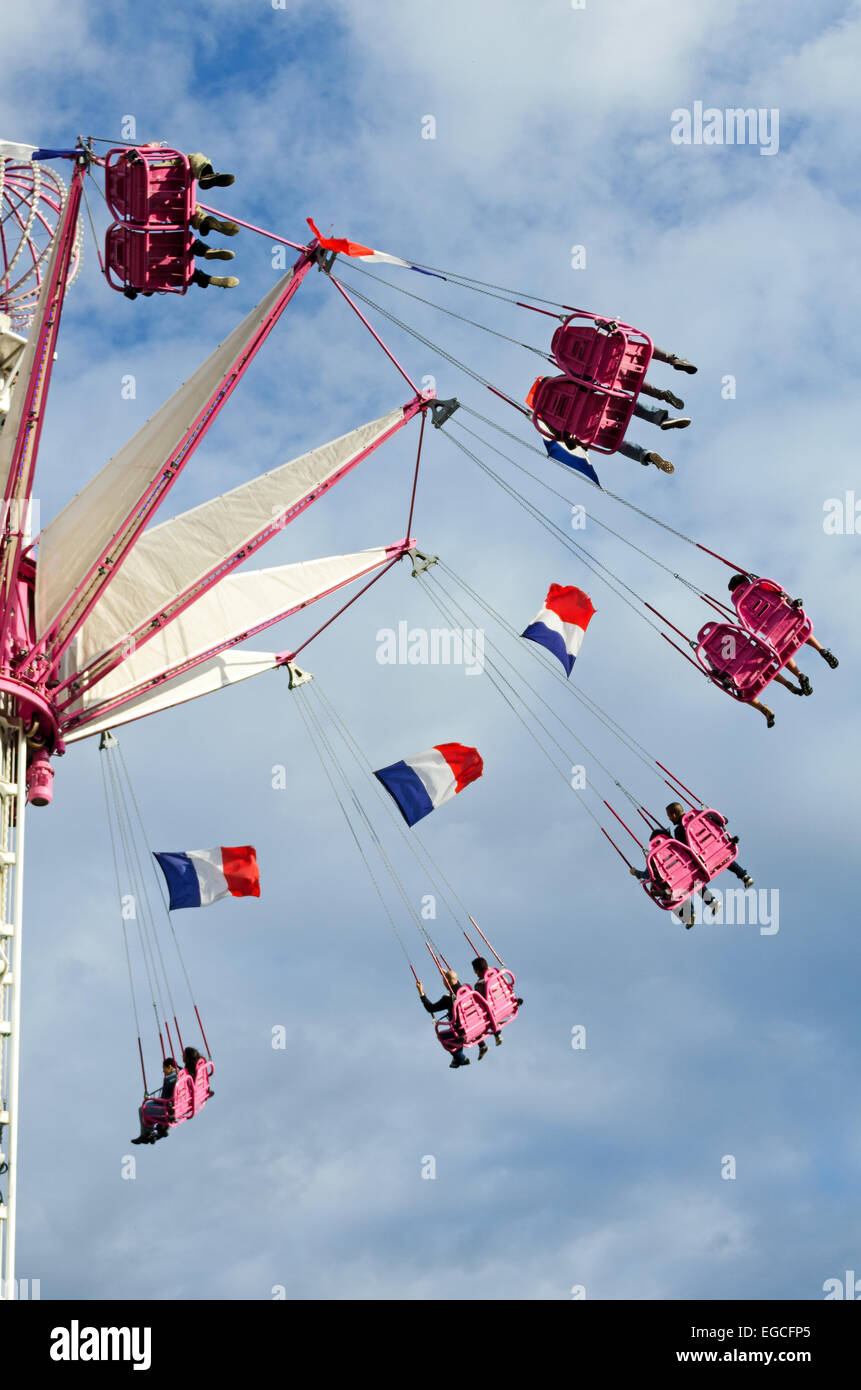 The French flag flies from carnival swings at the Fete des Tuileries in ...