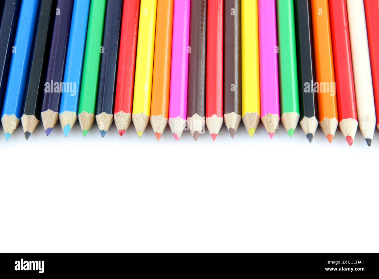 Mix colored crayons on a white background Stock Photo - Alamy