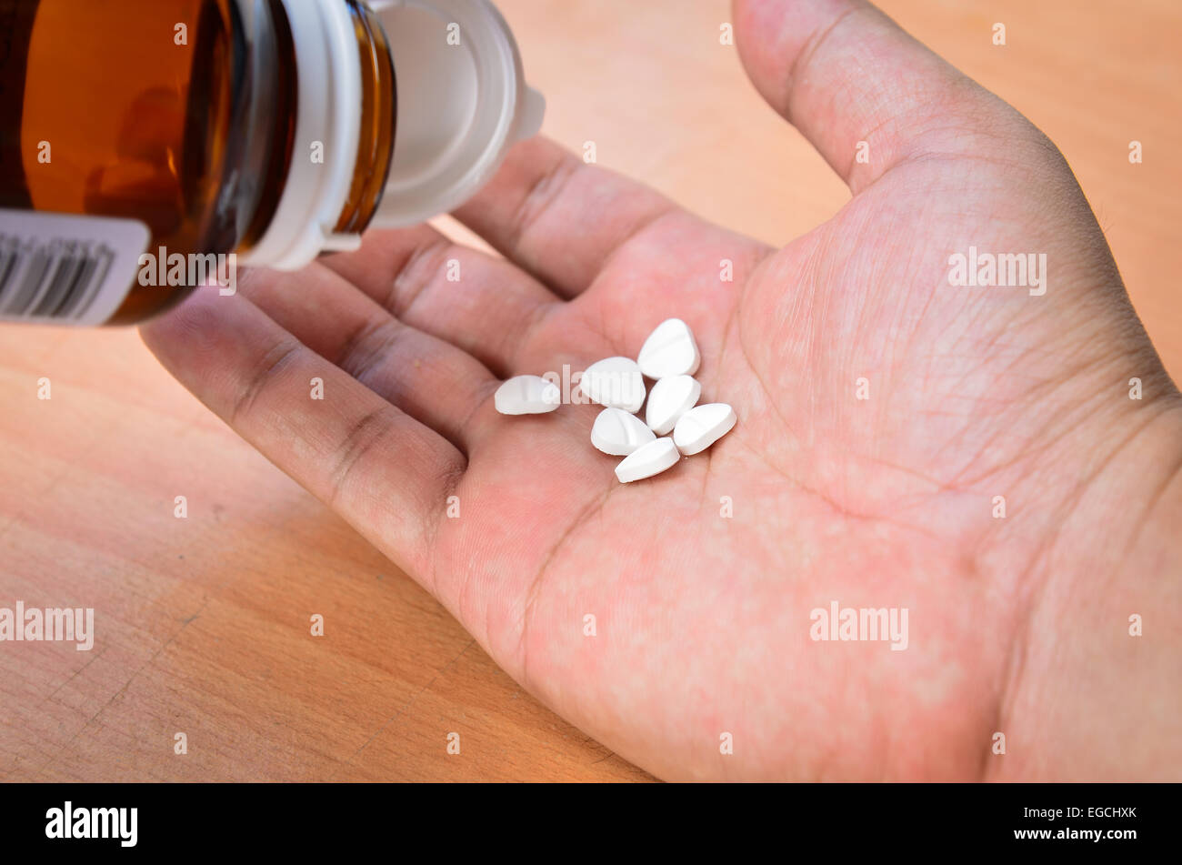 Pills as a heart on hand Stock Photo - Alamy
