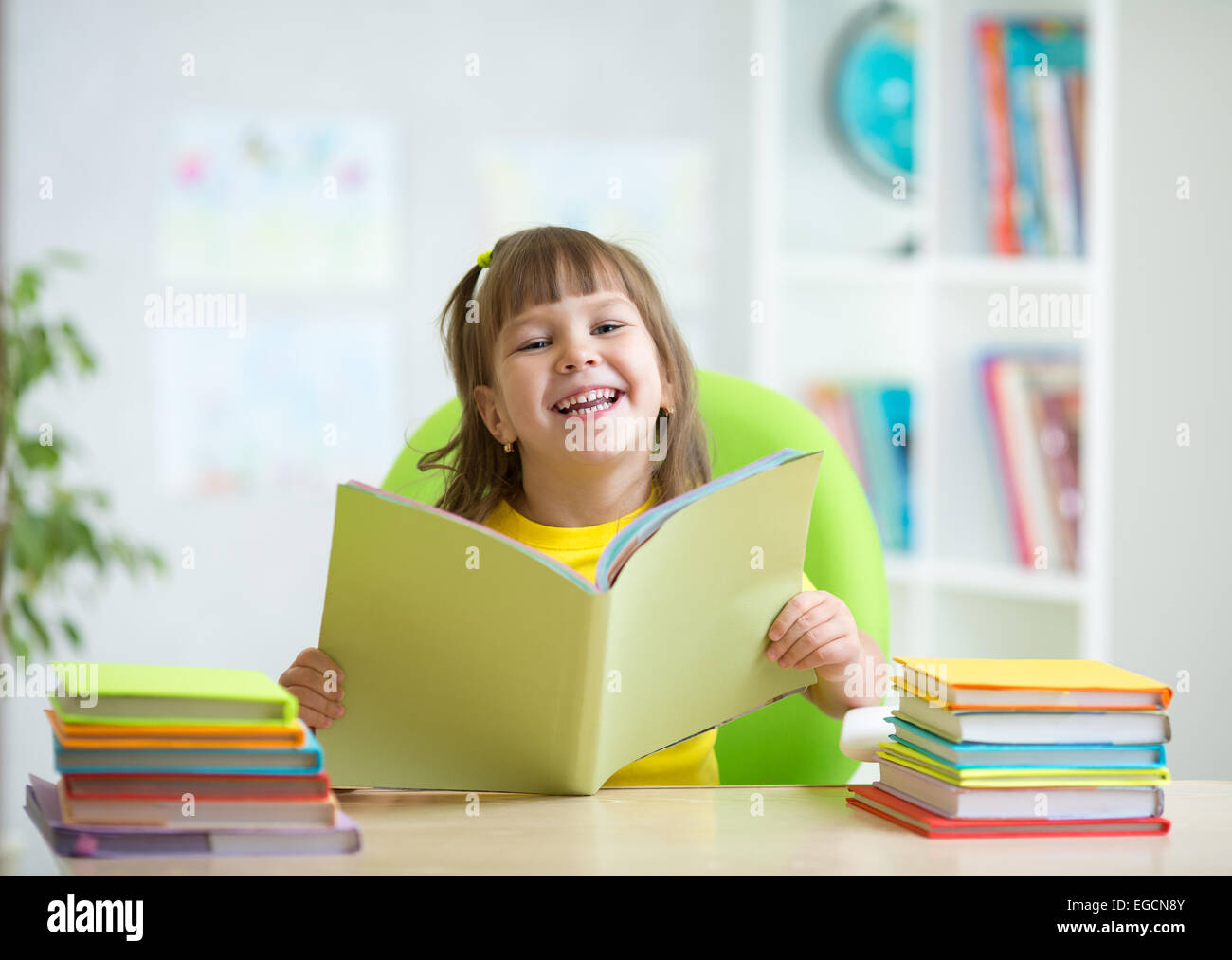 Happy child with opened book Stock Photo - Alamy