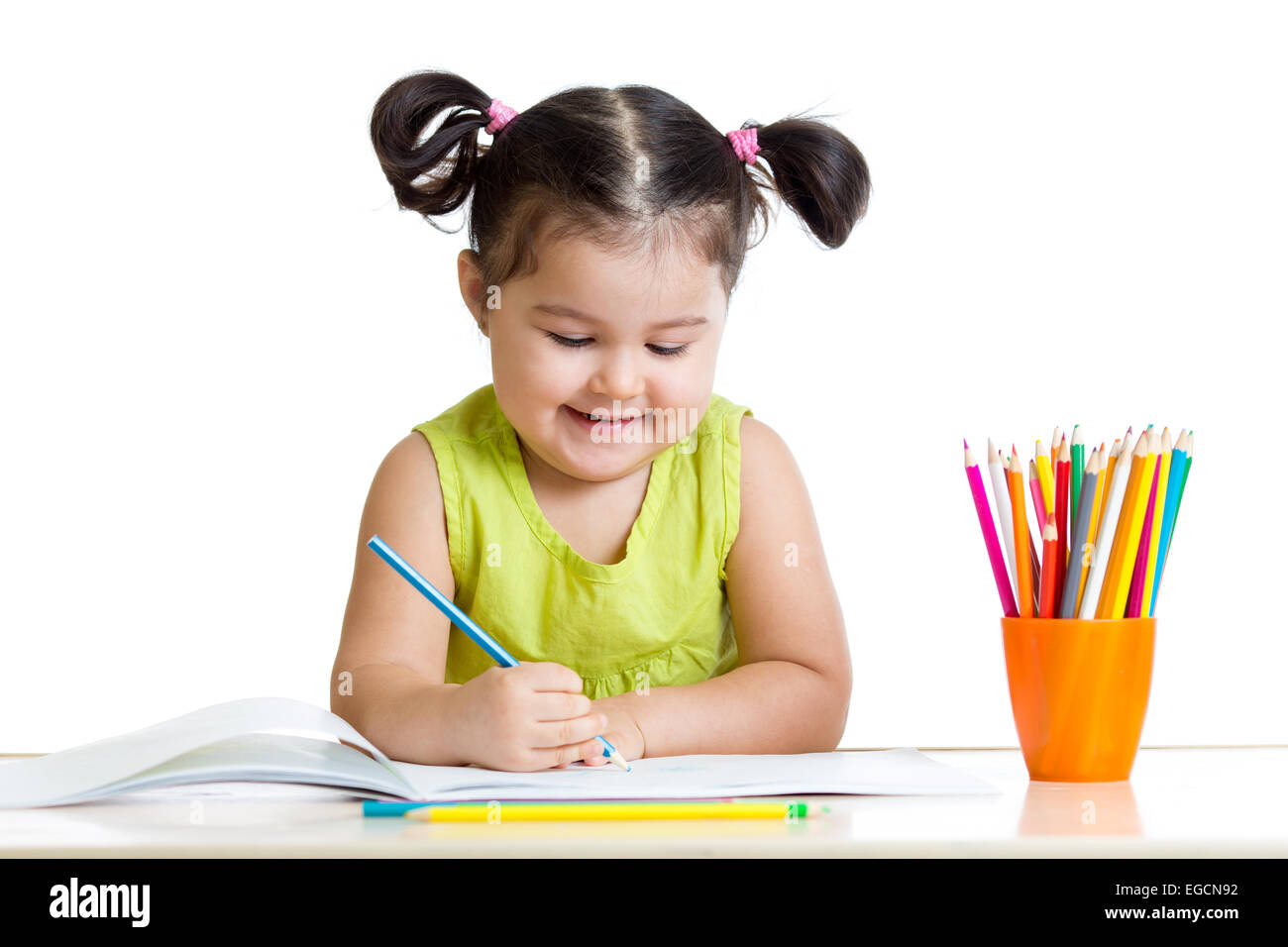 Cute kid drawing with colorful pencils and smiling Stock Photo - Alamy