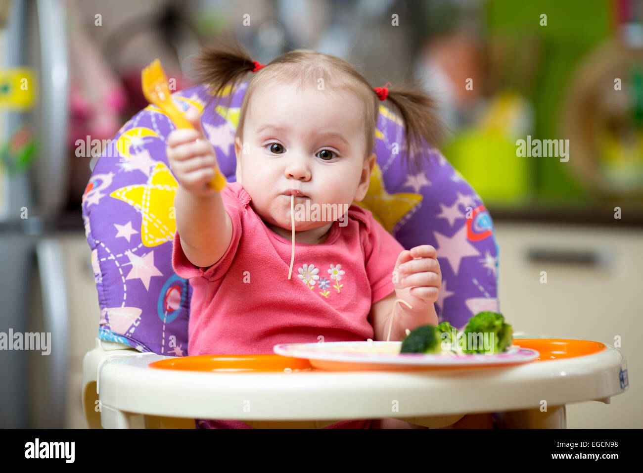 kid eating food on kitchen Stock Photo - Alamy