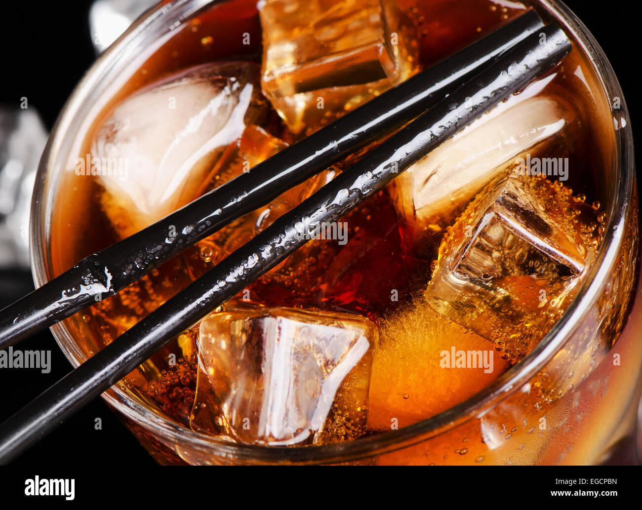 Glass of cola with ice cube. Selective focus Stock Photo - Alamy