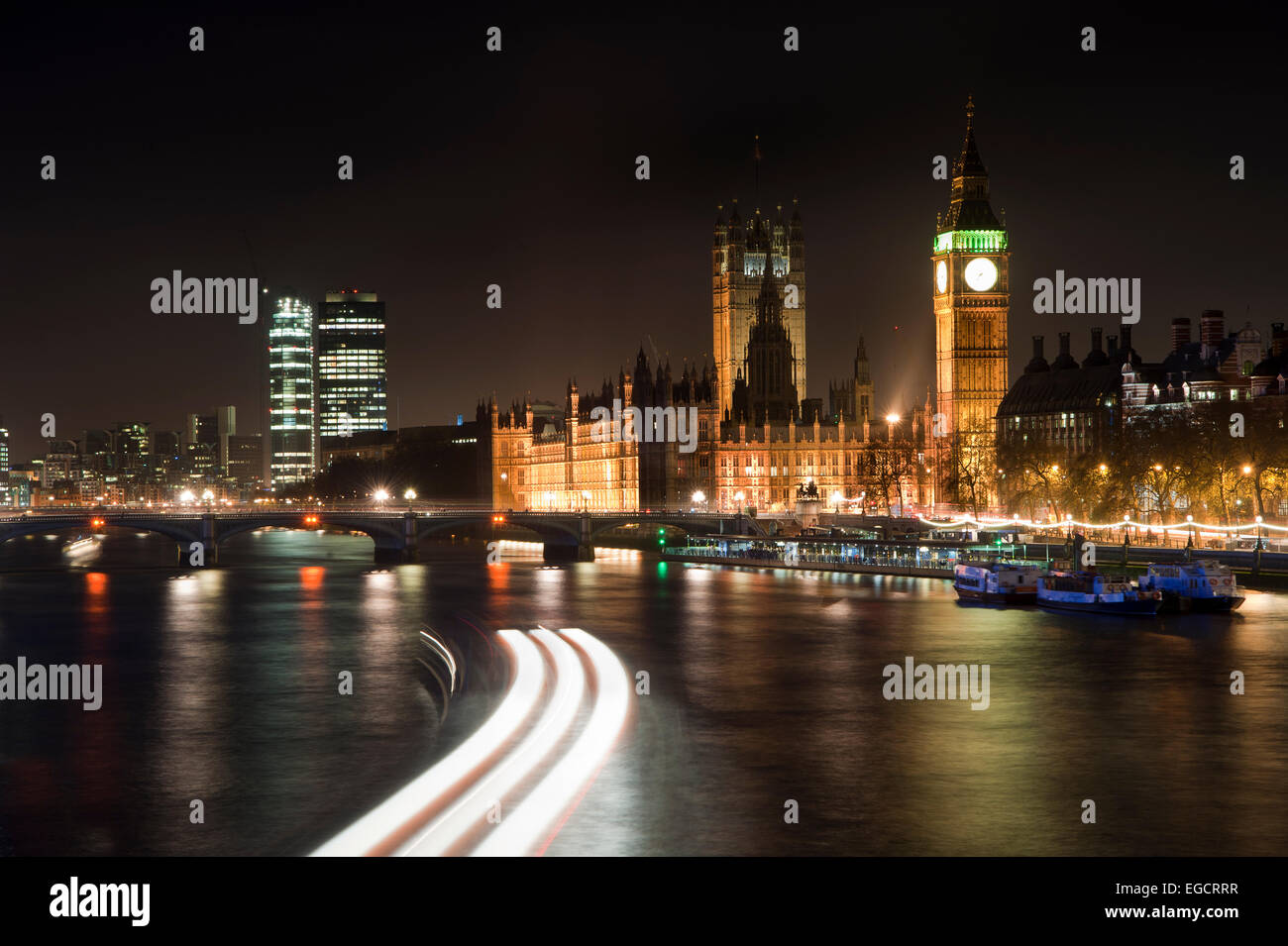 View along River Thames at night towards Houses of Parliament and Big ...