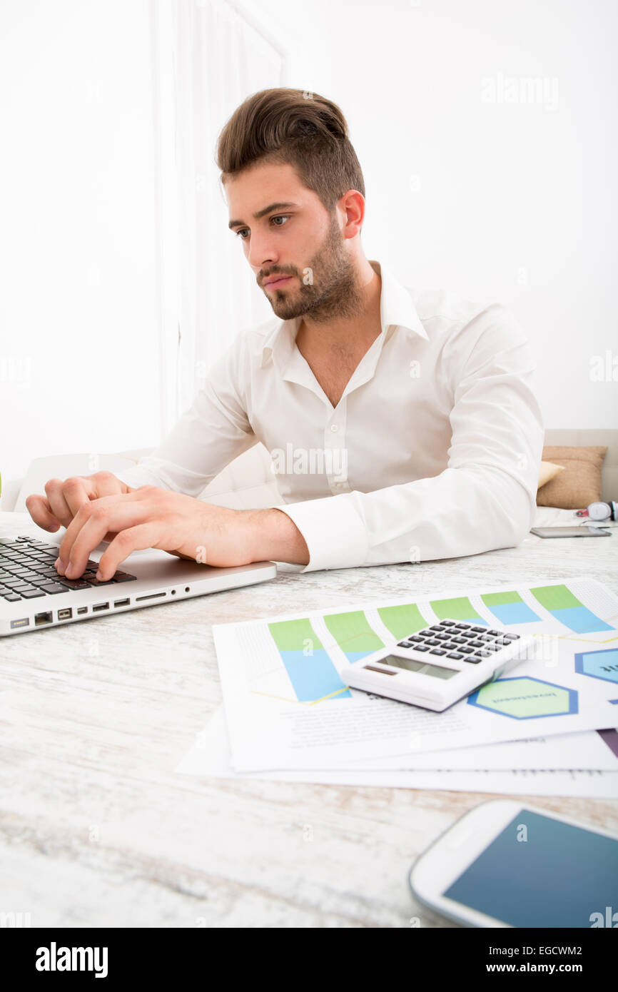 A young man working at home with a Laptop computer Stock Photo - Alamy