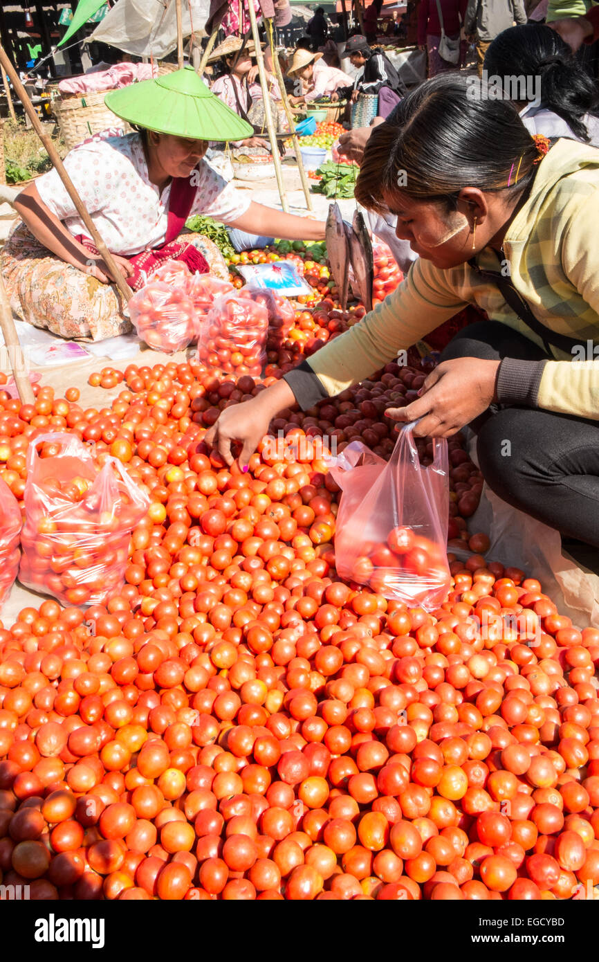Locals at 5 Day Market, a rotating system,on banks of Inle Lake. Here ...