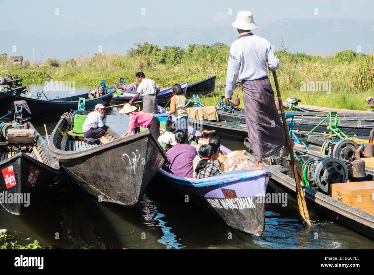Locals at 5 Day Market, a rotating system,on banks of Inle Lake. Here ...