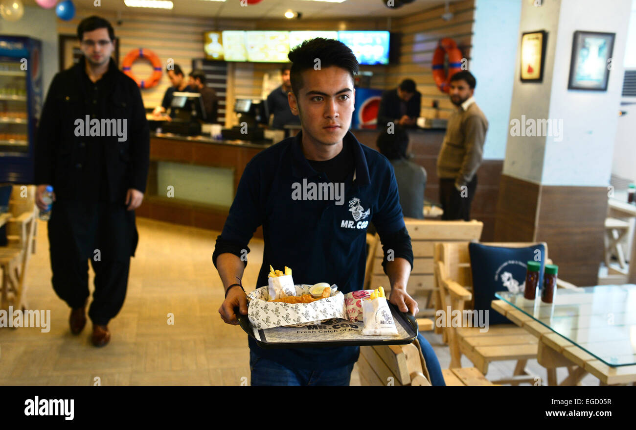 An Afghan waiter delivers the food ordered by a customer at the newly ...