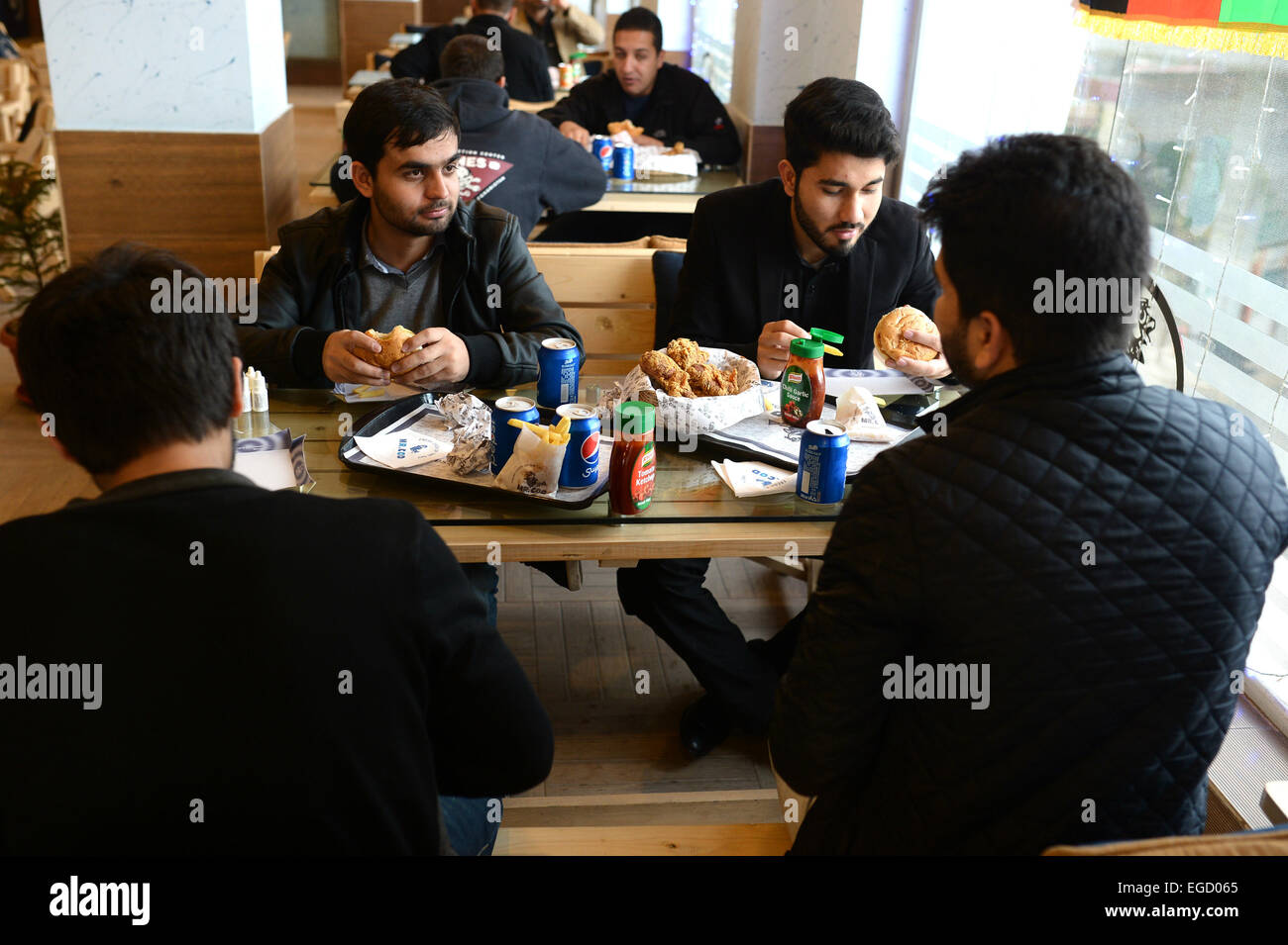 Afghan Samim Moneb (first from right) eating fish and chips with his ...