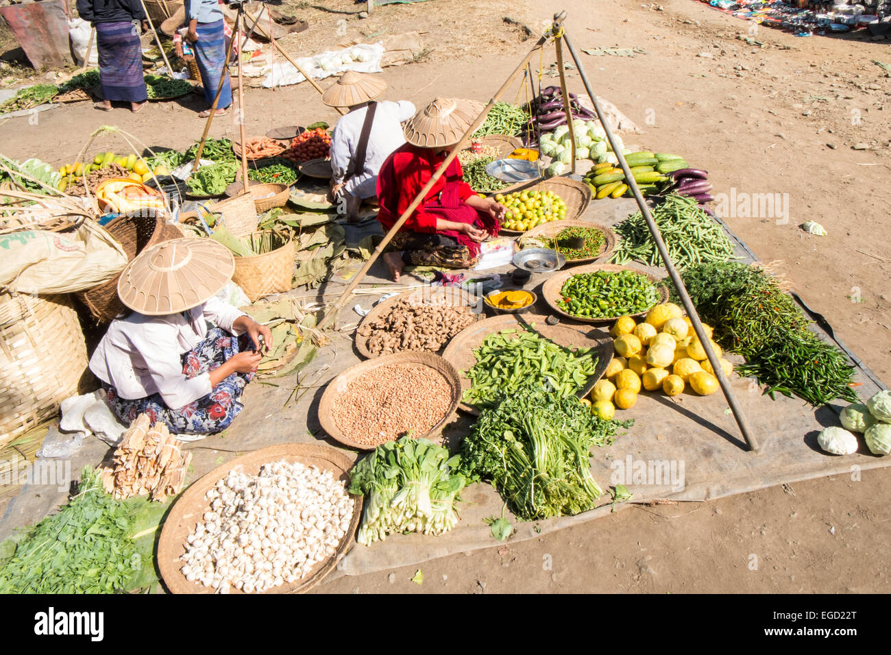 Locals at 5 Day Market, a rotating system,on banks of Inle Lake. Here ...