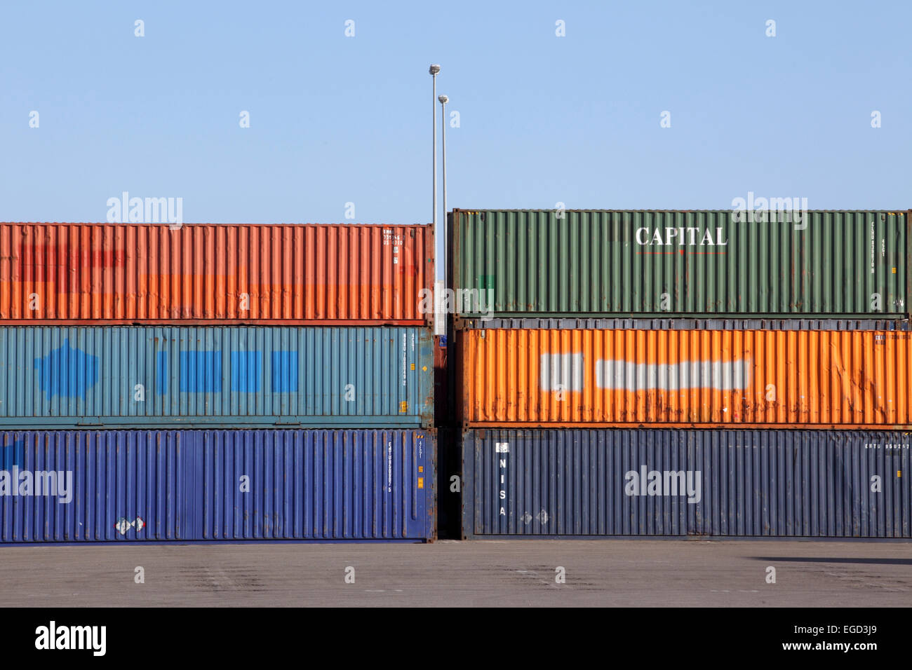 Contrasting and colorful stacks of shipping containers piled-up at ...