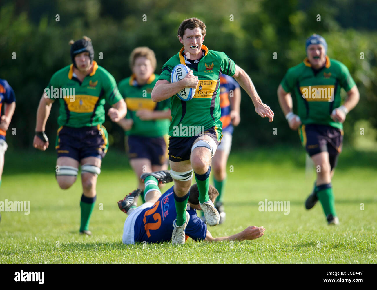 Rugby player in action running with the ball Stock Photo - Alamy