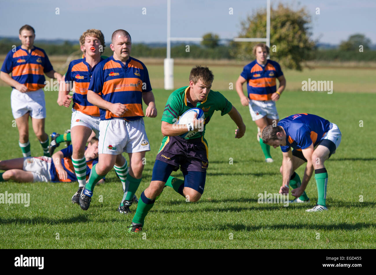 Rugby player in action running with the ball Stock Photo - Alamy