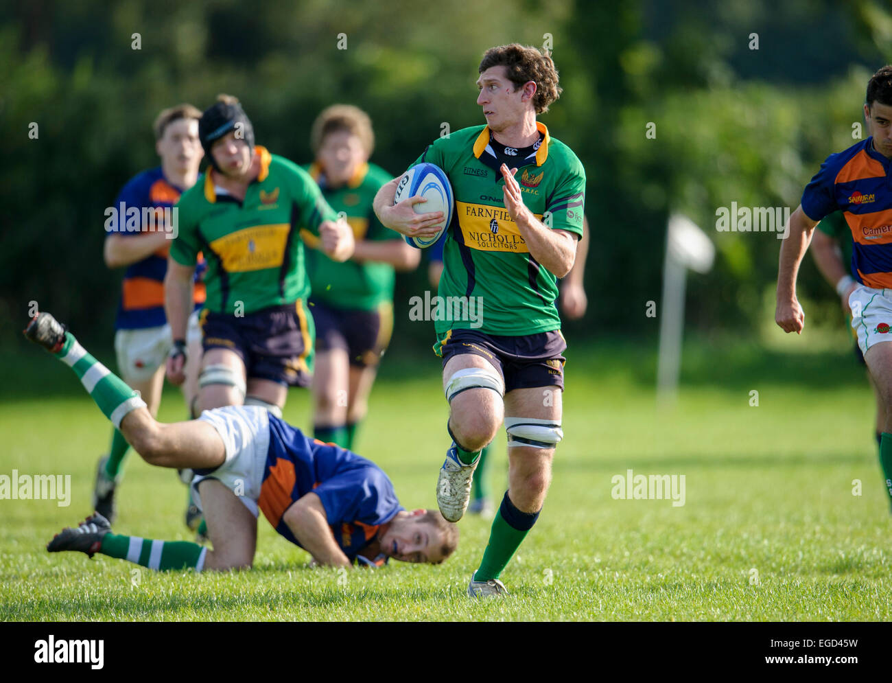 Rugby player in action running with the ball Stock Photo - Alamy