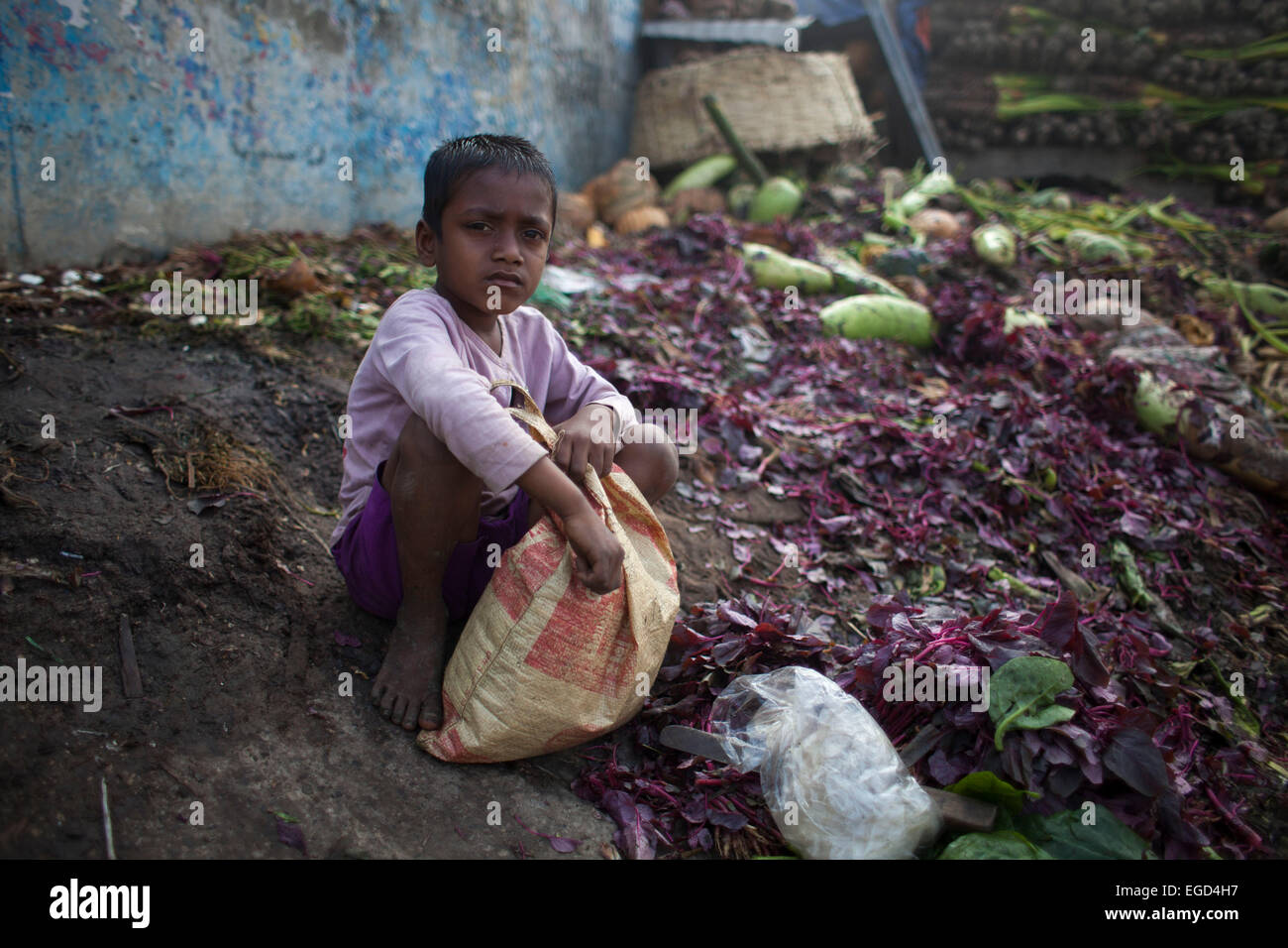 Slum boy Shawqat collecting vegetable from rotten garbage at Shambazar ...