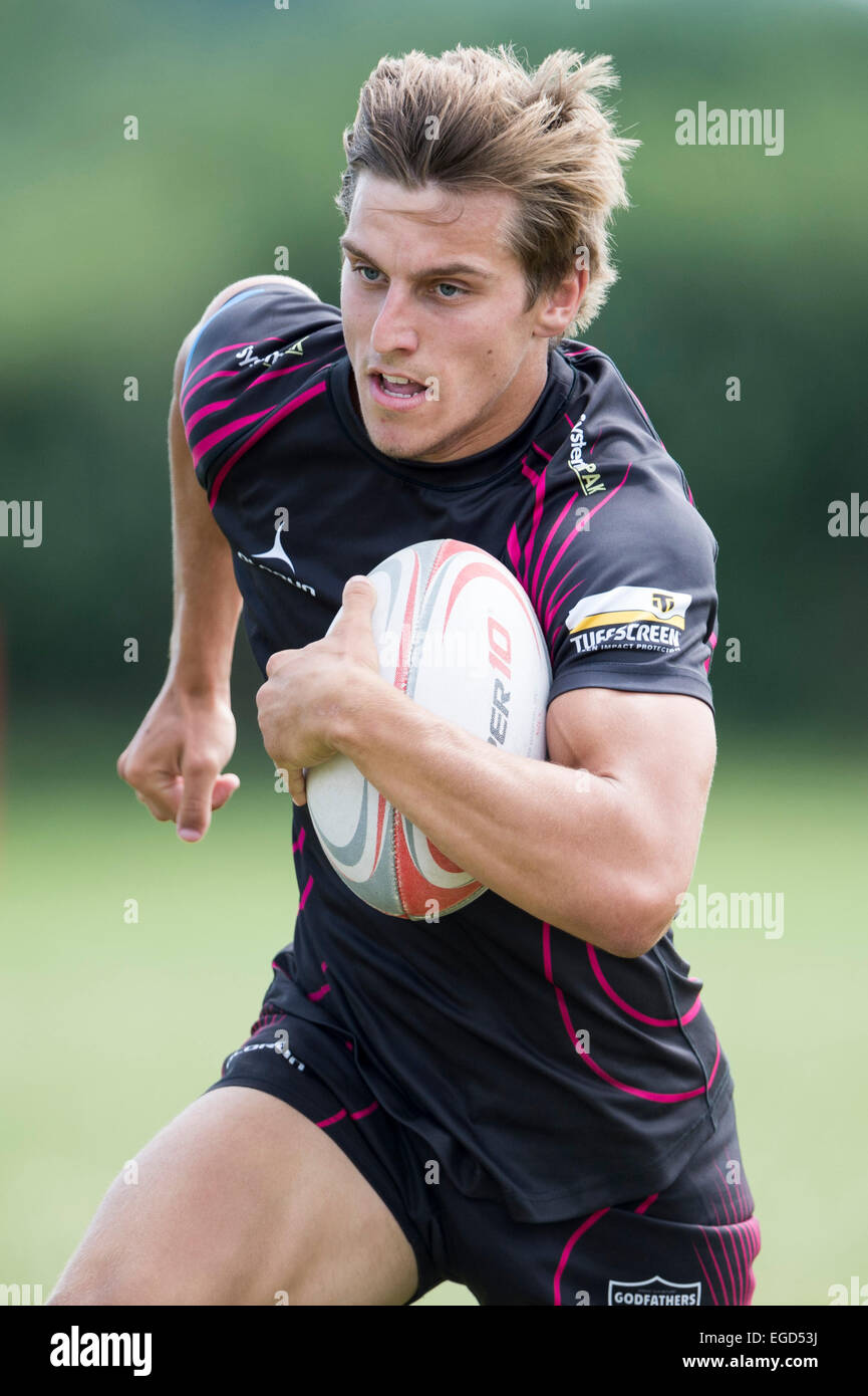 Rugby player in action running with the ball Stock Photo - Alamy