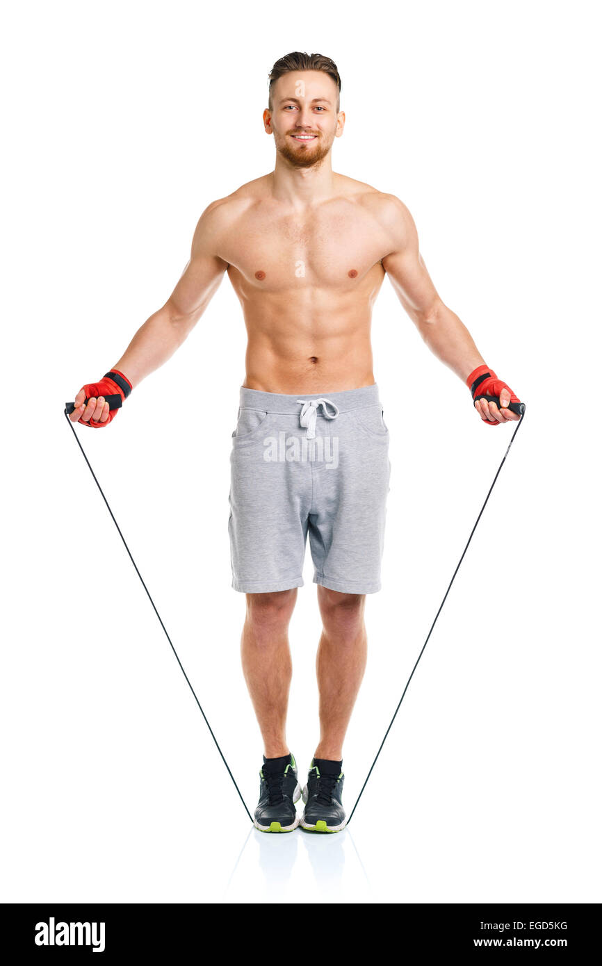 Athletic attractive man jumping on a rope on the white background Stock ...