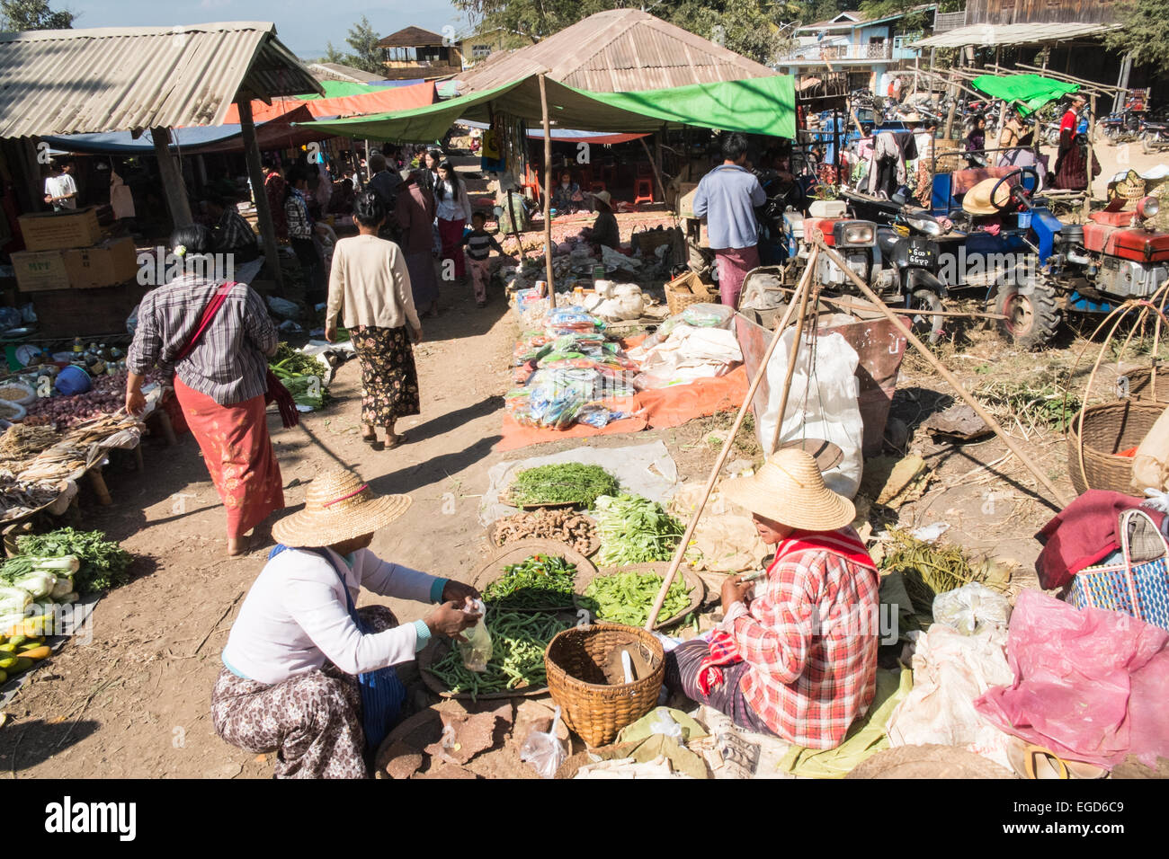 Locals at 5 Day Market, a rotating system,on banks of Inle Lake. Here ...