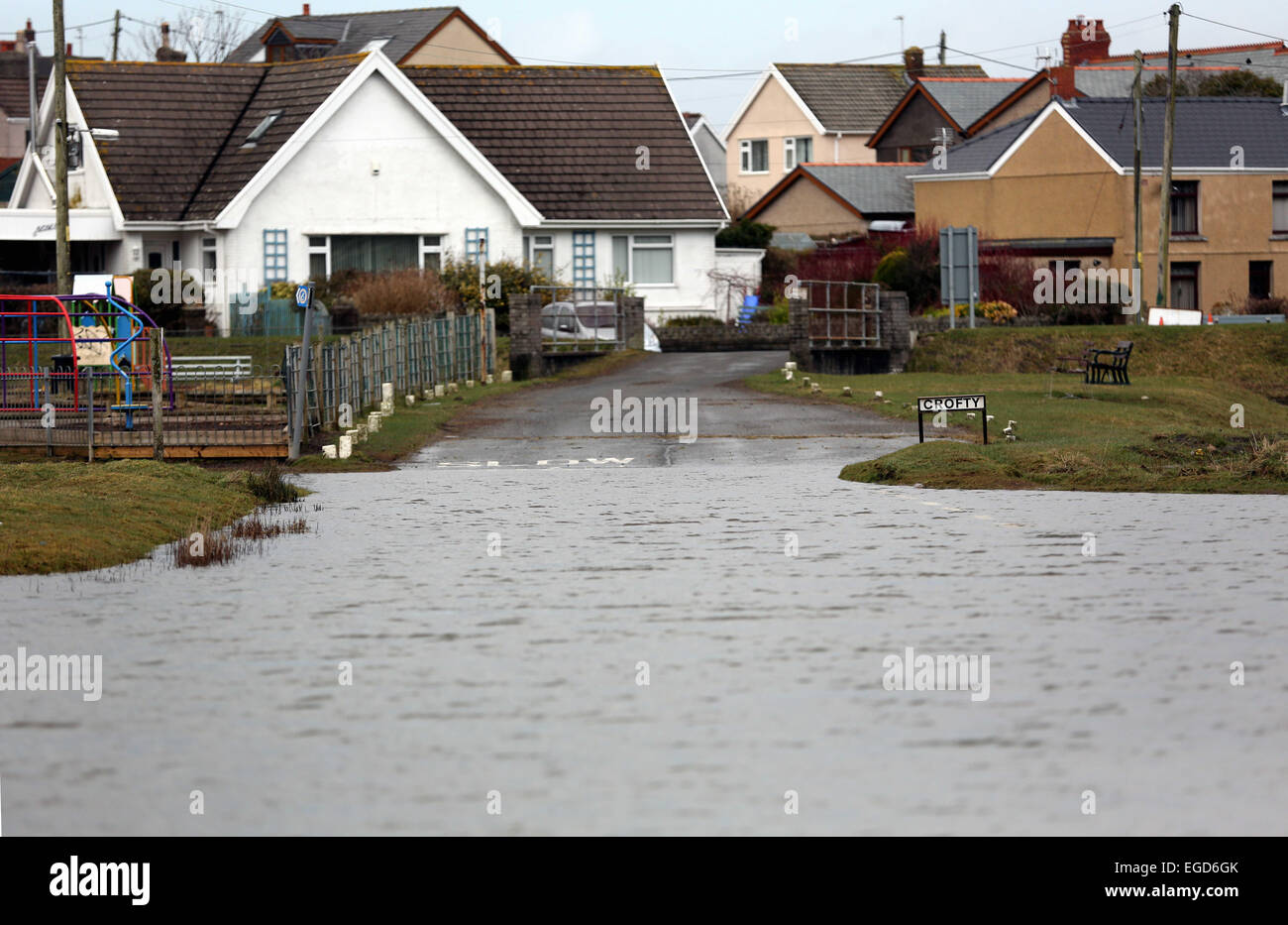 Crofty, UK. Monday 23 February 2015 Pictured: The flooded road during ...