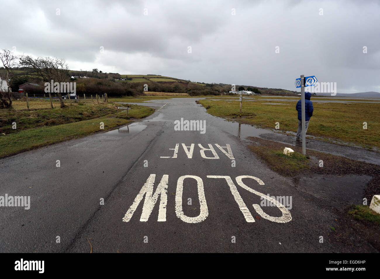 Crofty, UK. Monday 23 February 2015 Pictured: The flooded road during ...