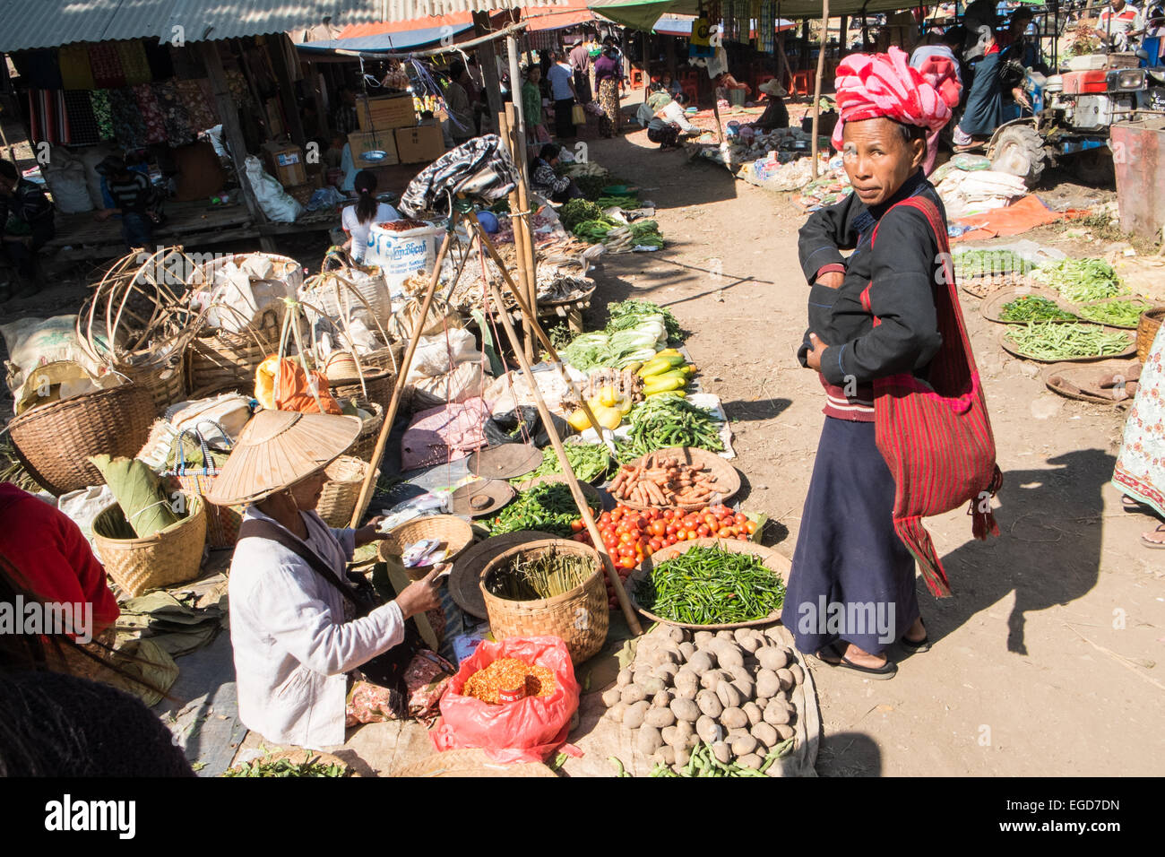 Locals at 5 Day Market, a rotating system,on banks of Inle Lake. Here ...