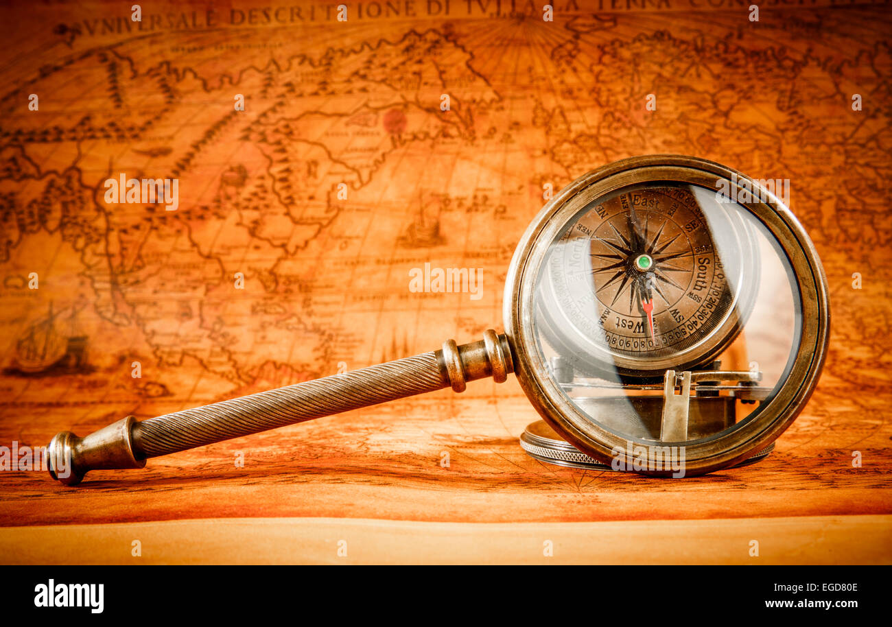 Vintage still life. Vintage magnifying glass lies on an ancient world ...