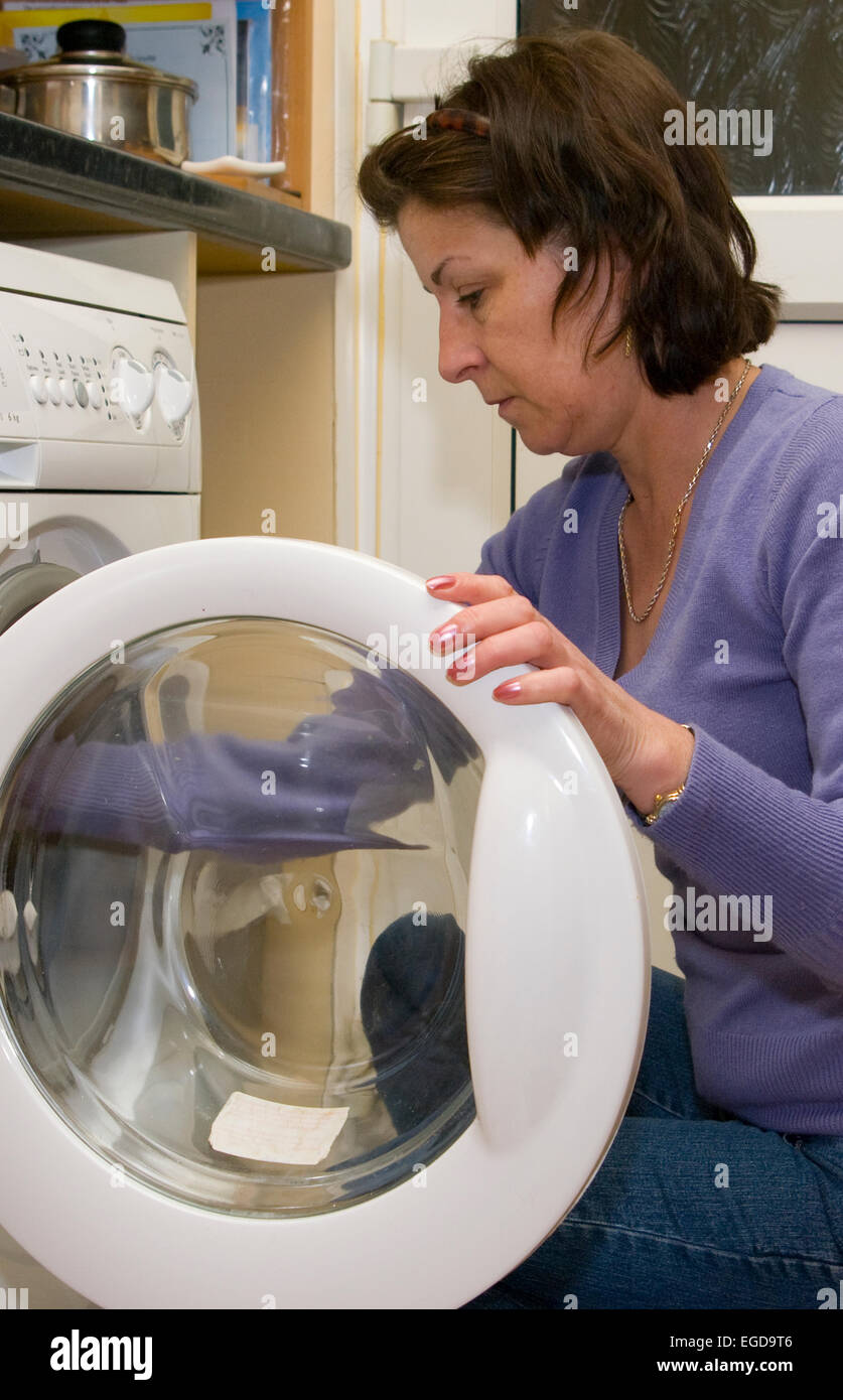 Woman Loading The Washing Machine Stock Photo - Alamy