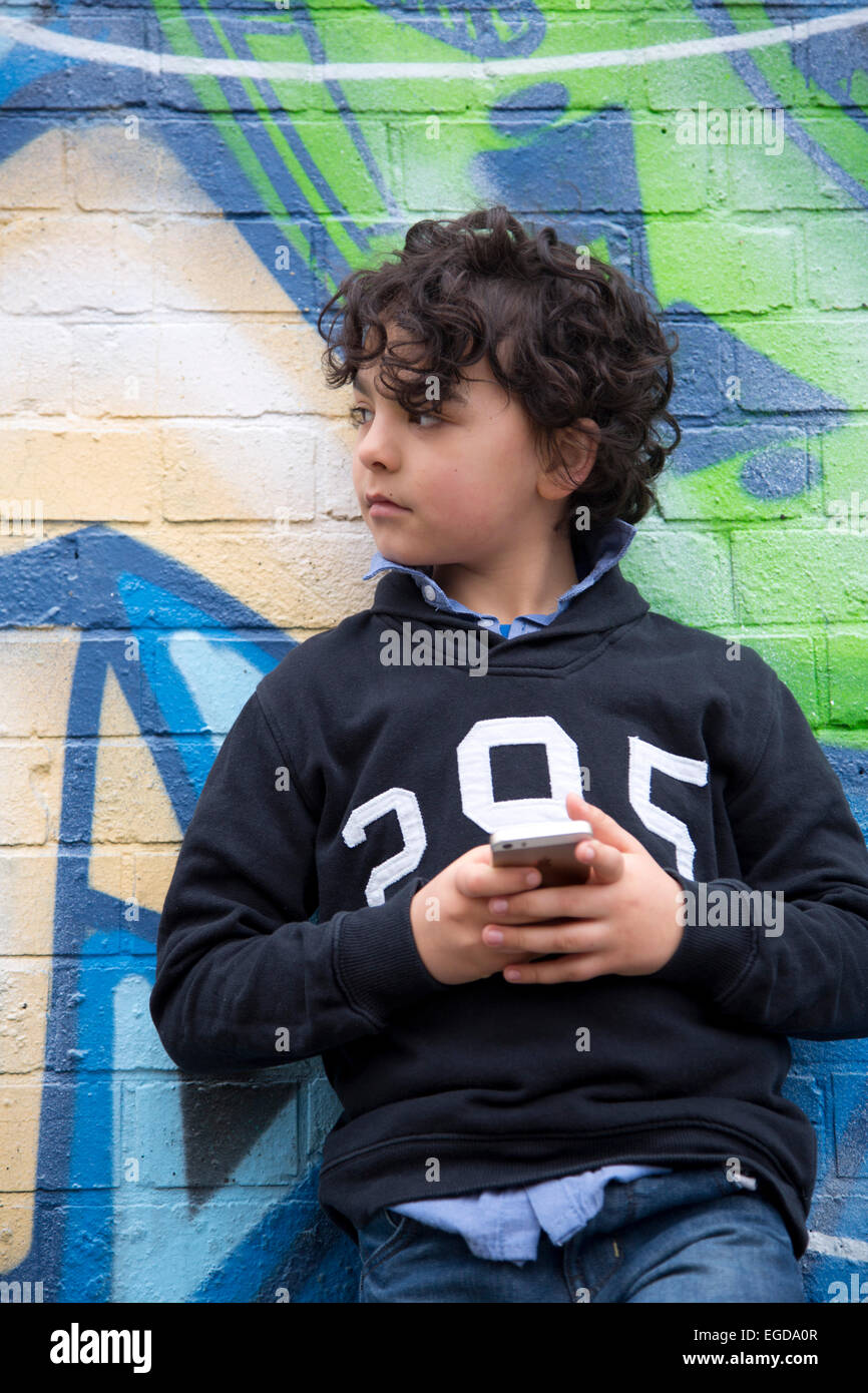 Child on mobile phone cell waiting for someone Stock Photo - Alamy