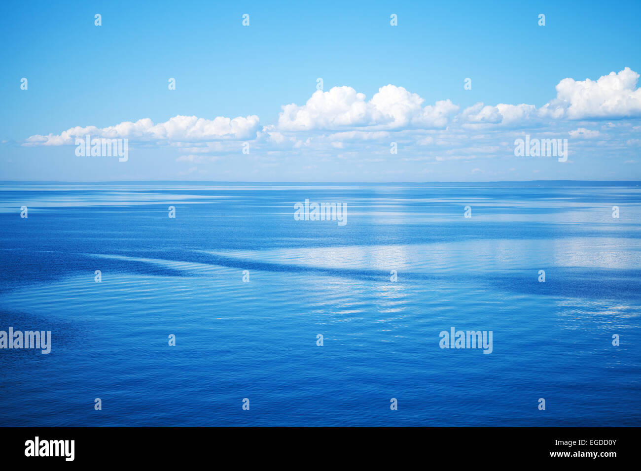 Seascape with blue water and cloudy sky Stock Photo - Alamy