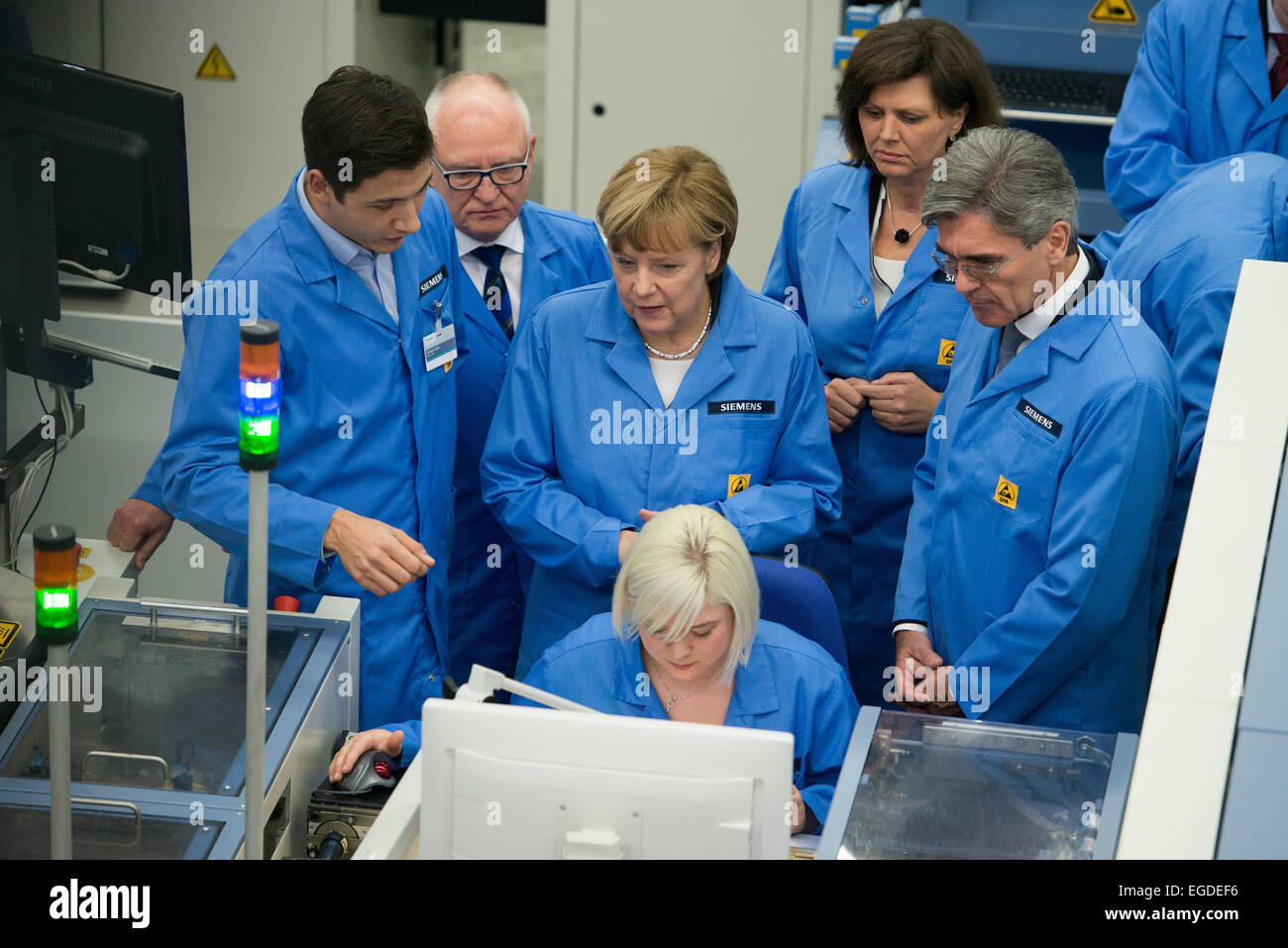 Amberg, Germany. 23rd Feb, 2015. Chancellor Angela Merkel (C)stands ...