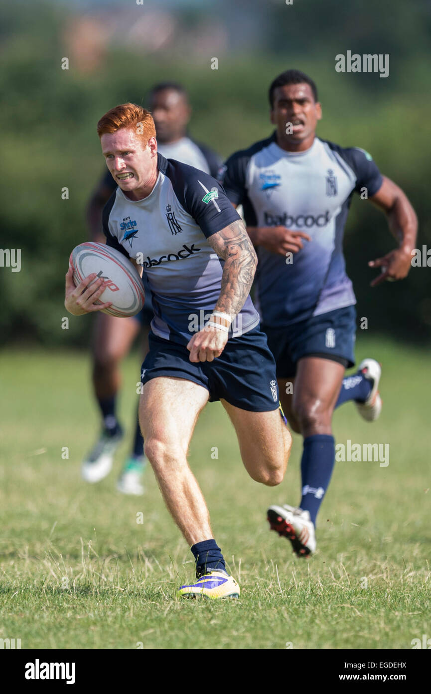Rugby player running with ball Stock Photo - Alamy