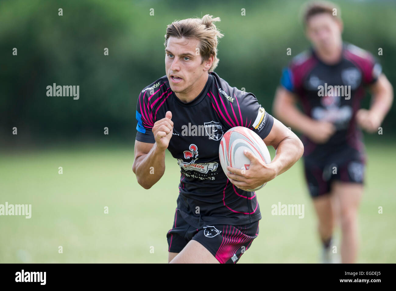 Rugby player running with ball Stock Photo - Alamy
