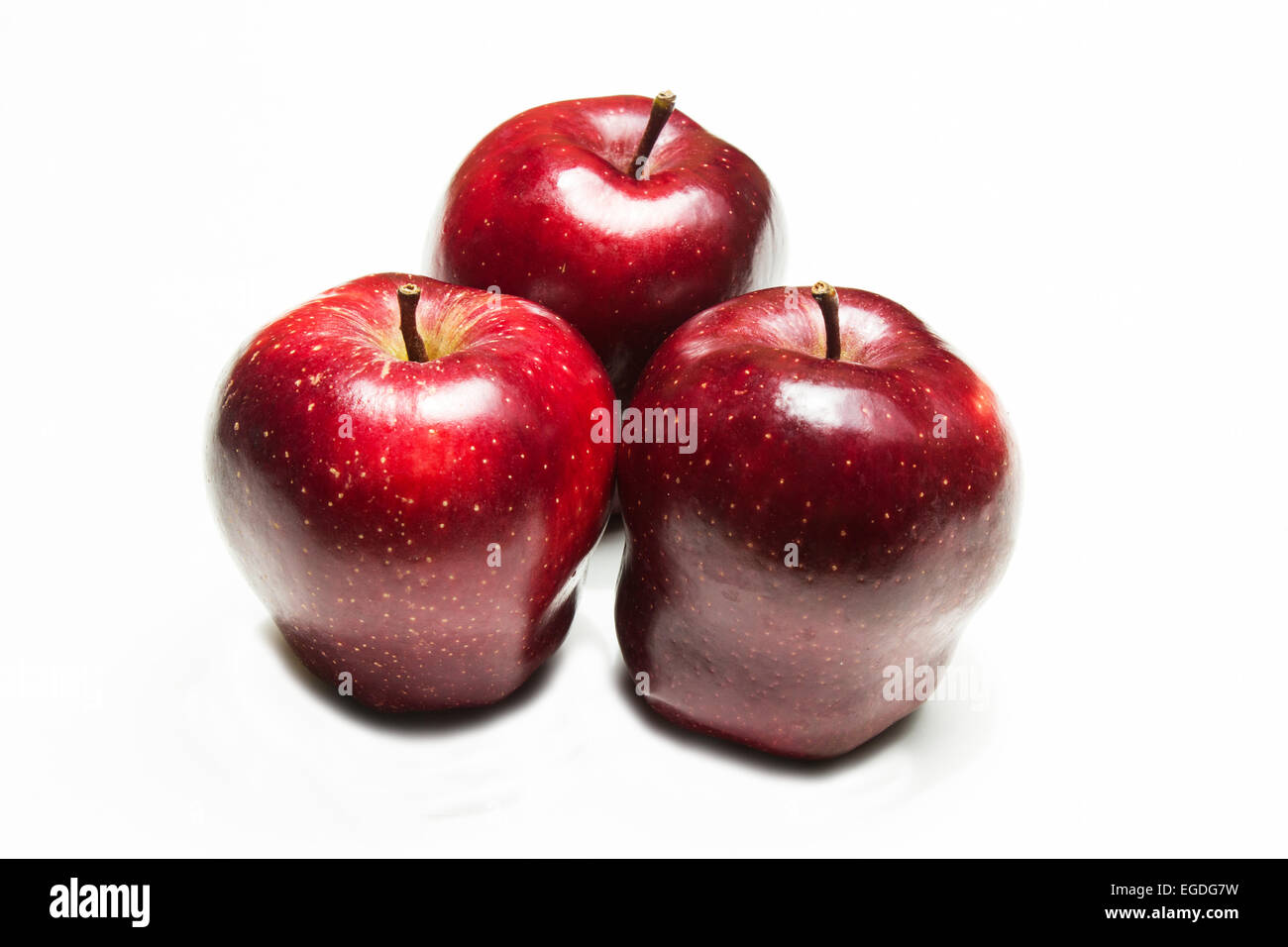 Three red apples on white background Stock Photo - Alamy
