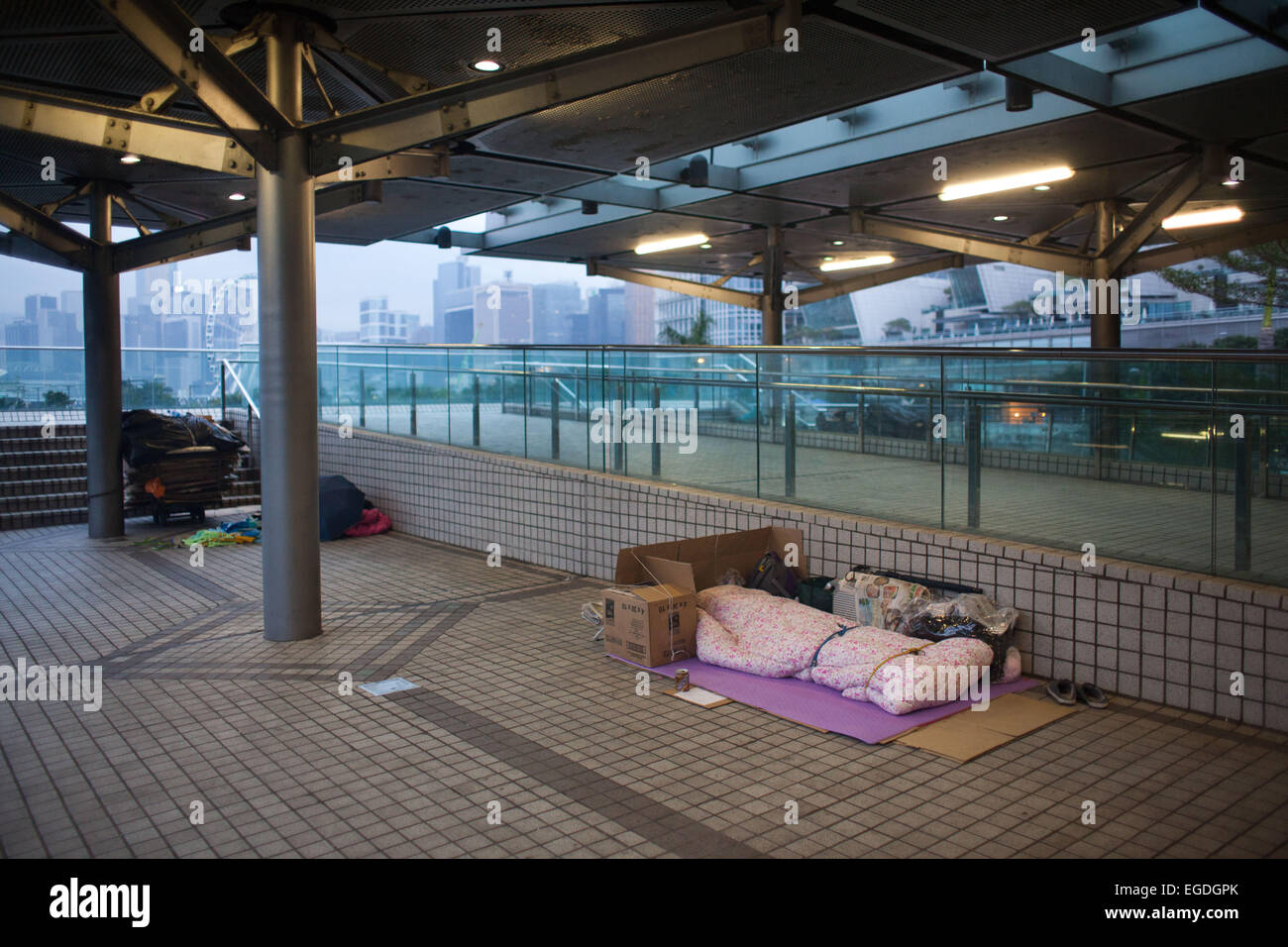 Two homeless people sleep with their collected cardboard under the ...