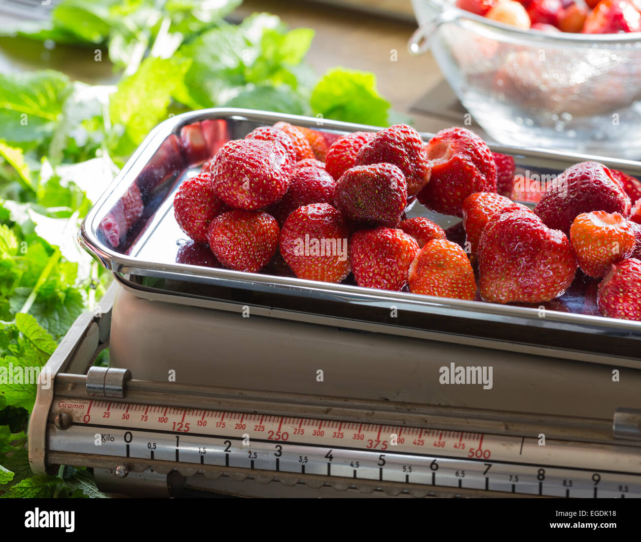 Strawberry jam cooking weigh the strawberries Stock Photo - Alamy