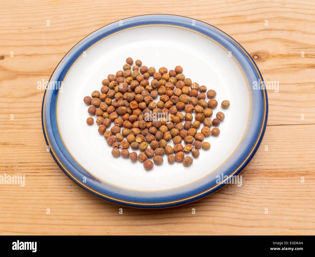 Carlin or Maple peas Pisum sativum on a blue and white plate wooden ...