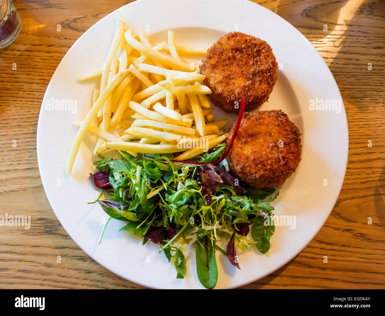A simple pub lunch of home made fish cakes with salad garnish and ...