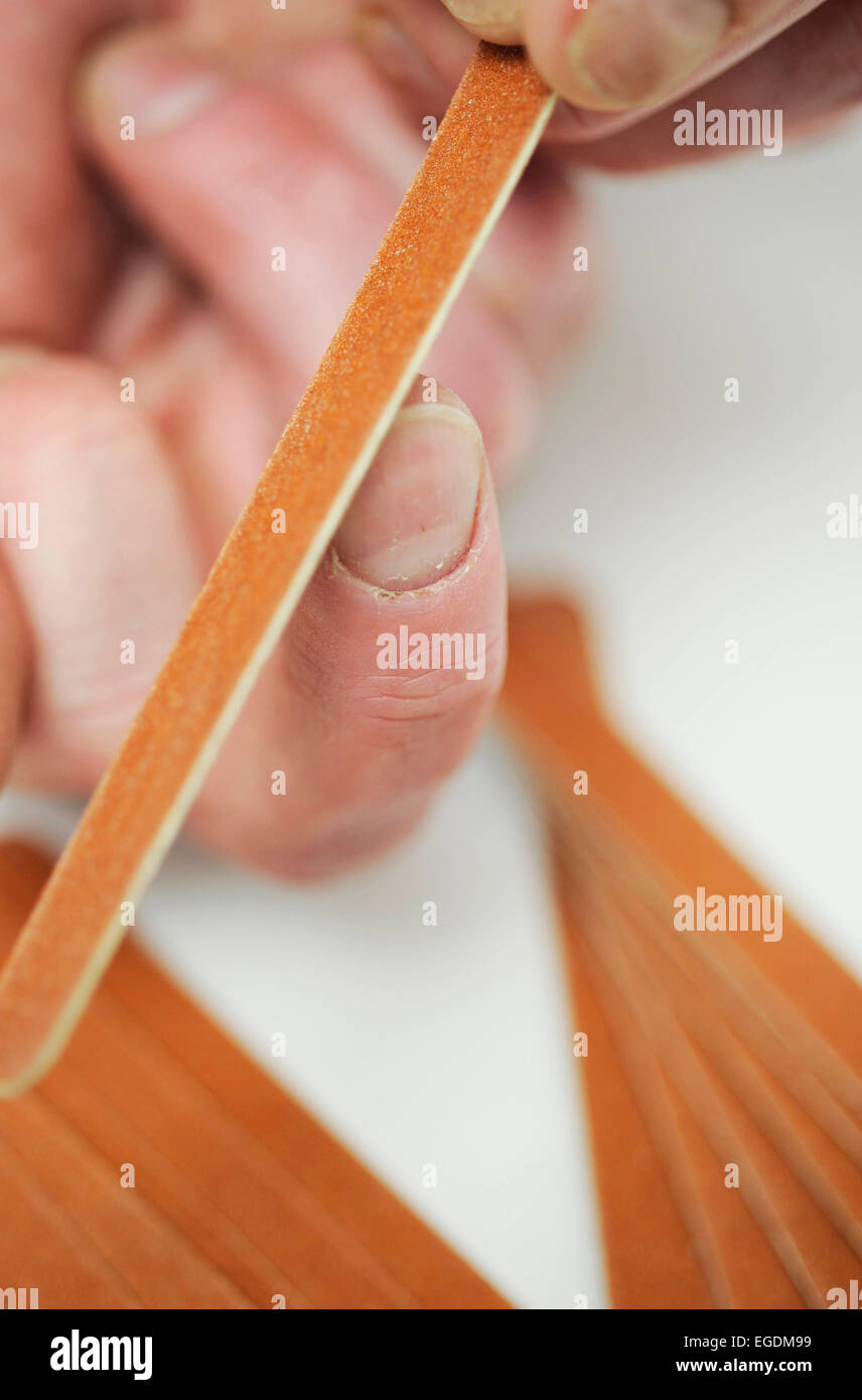 Man filing his nails Stock Photo - Alamy
