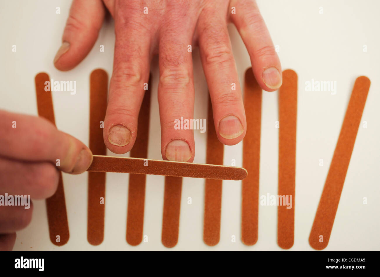 Man filing his nails Stock Photo - Alamy