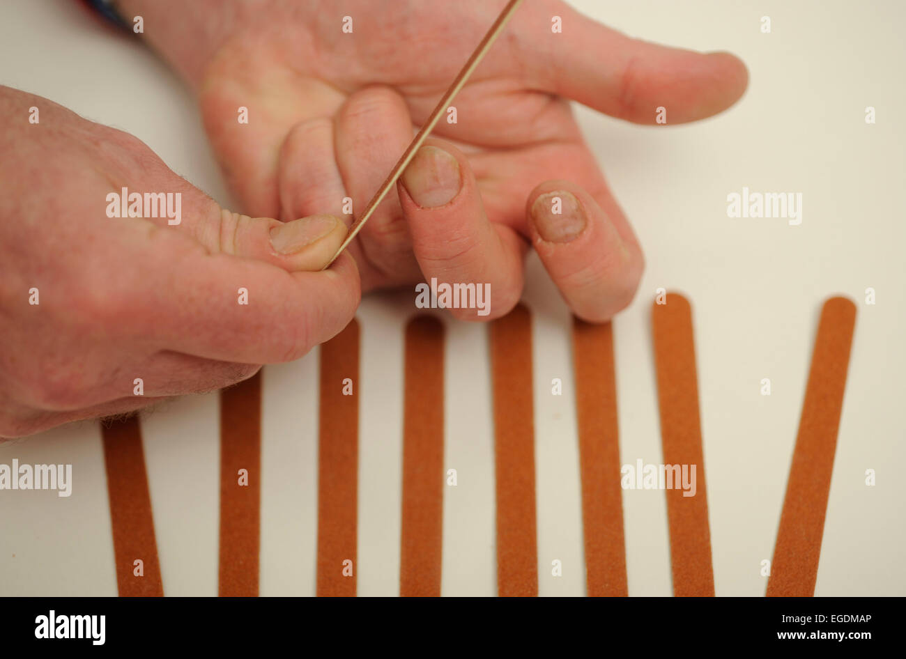 Man filing his nails Stock Photo - Alamy