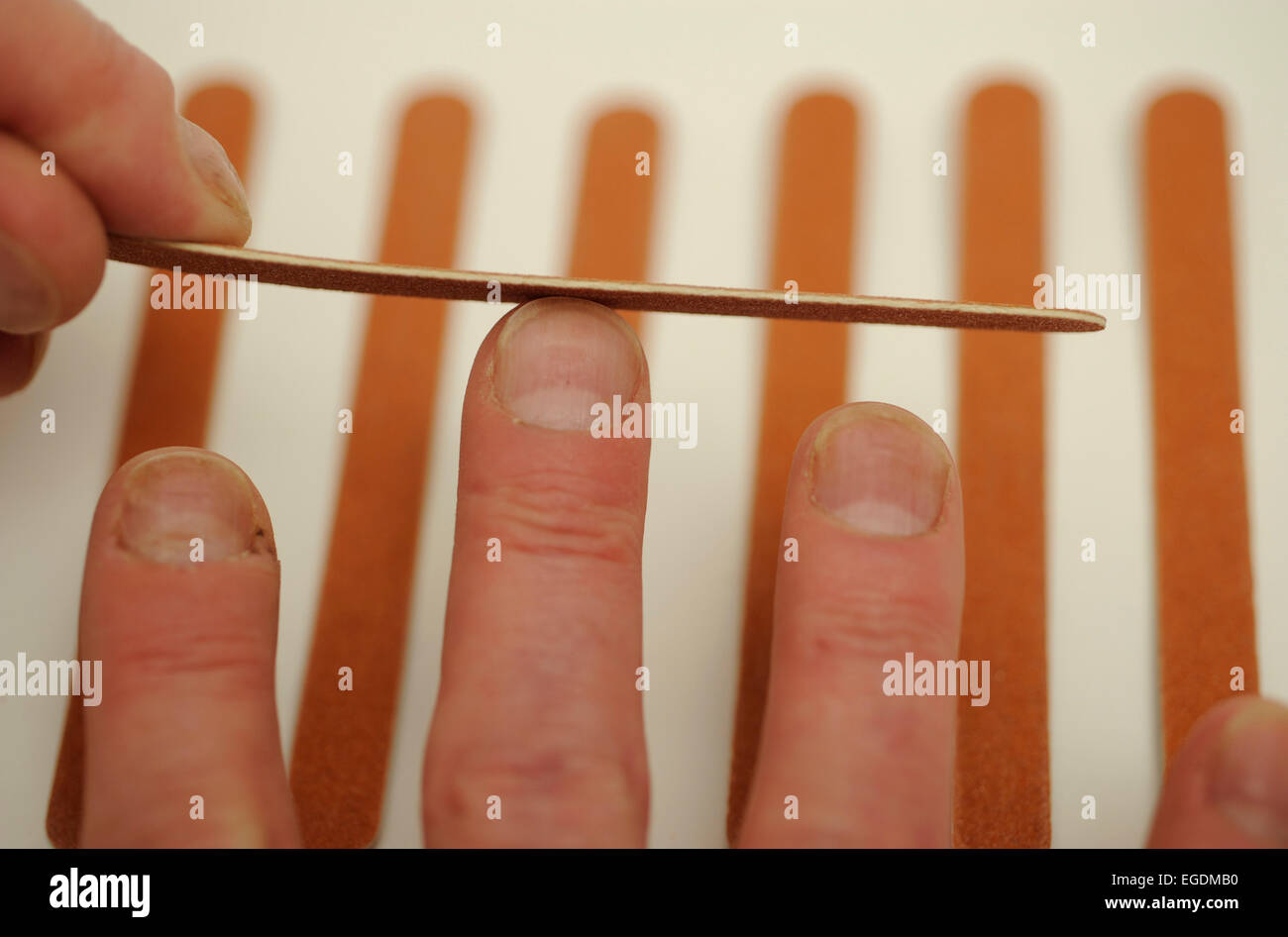Man filing his nails Stock Photo - Alamy