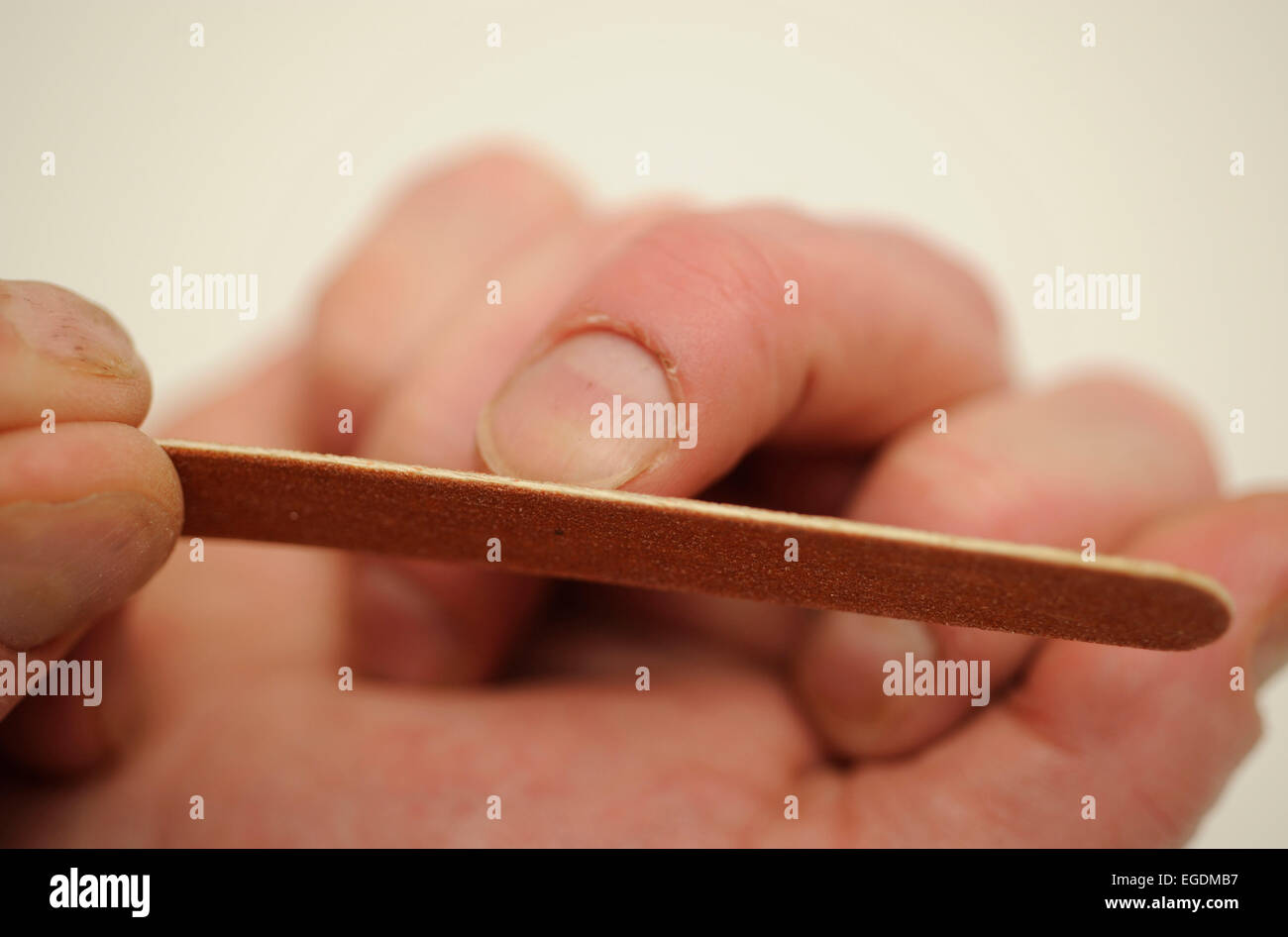 Man filing his nails Stock Photo - Alamy