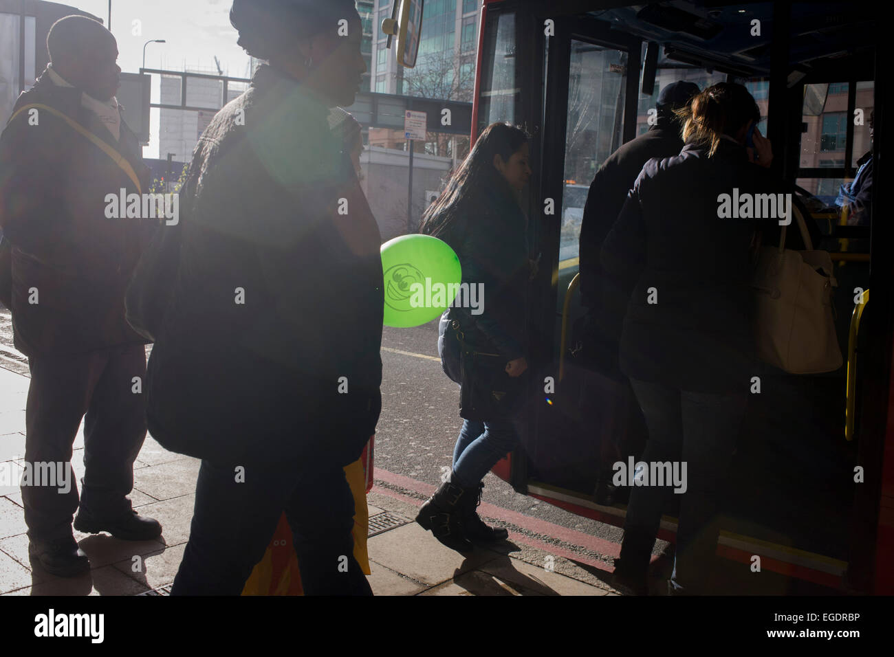 Passenger boards bus with green balloon at Vauxhall bus station, south ...