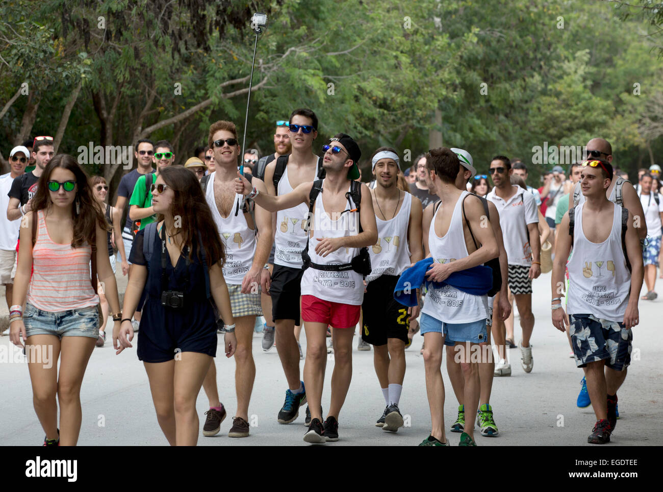 Man takes a selfie in a crowd of tourists on the entrance path to the ...