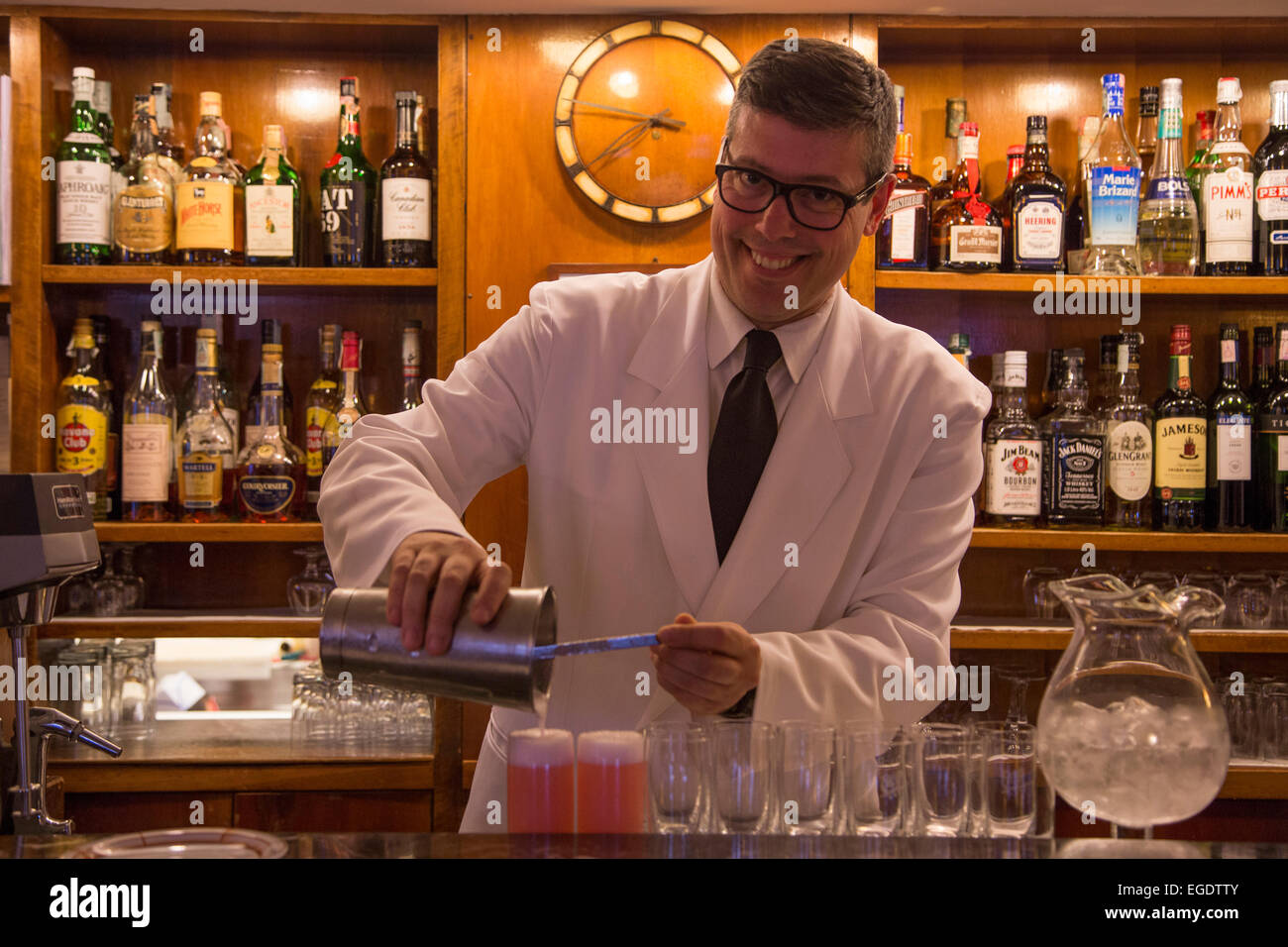Friendly barkeeper mixing delicious Bellini drinks in Harry's Bar ...