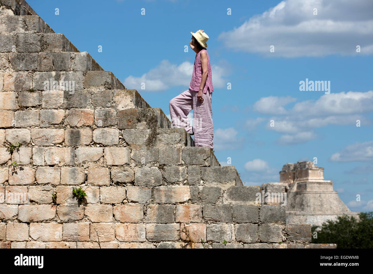 A woman walking up the stairs to the Governors Palace with the Pyramid ...