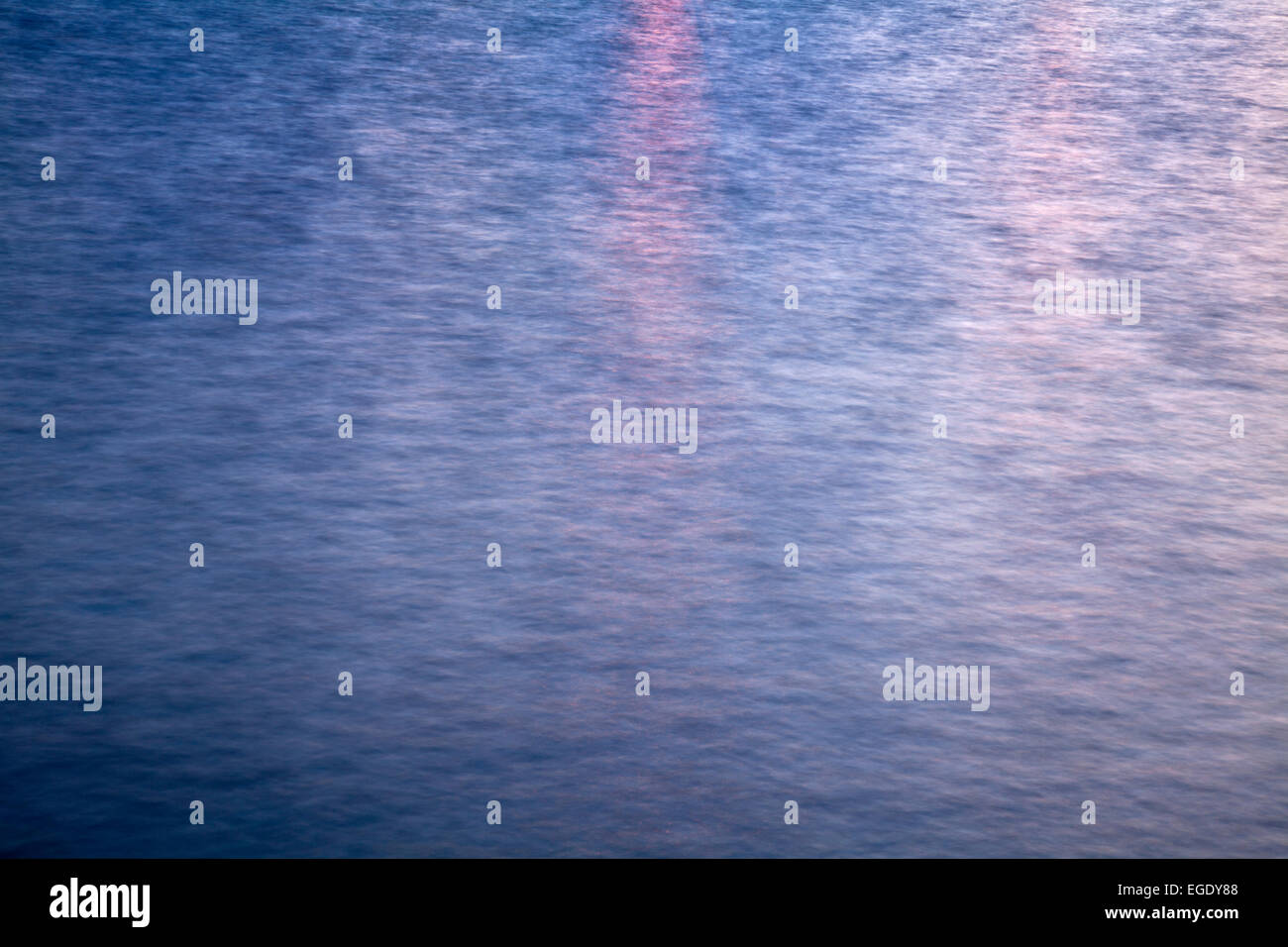 Sunset reflecting ocean surface Stock Photo - Alamy