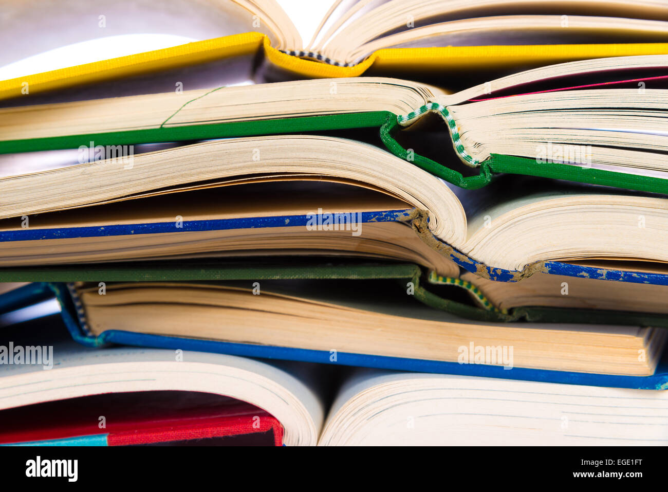 A stack of open, colorful book with a white background Stock Photo - Alamy