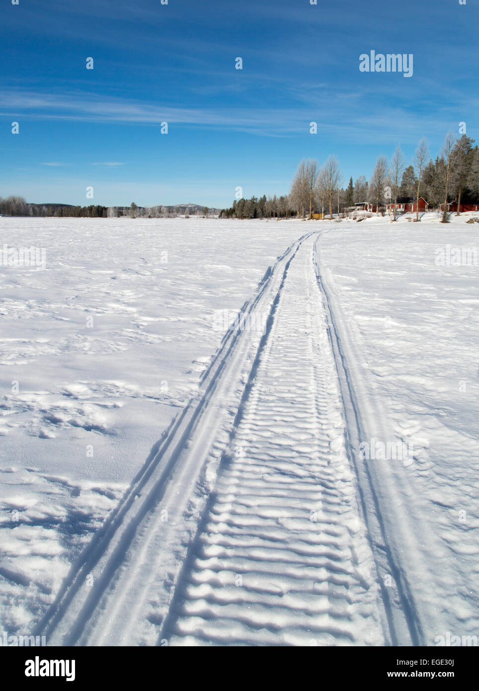Snowmobile Tracks on Frozen Lake Stock Photo - Alamy