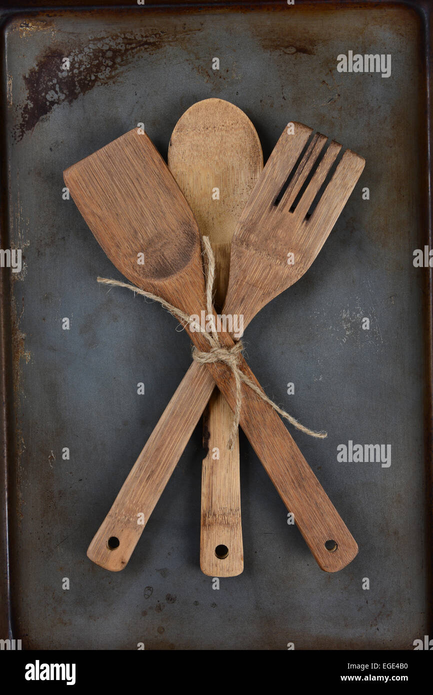 High angle shot of three wooden kitchen utensils crossed and tied with ...